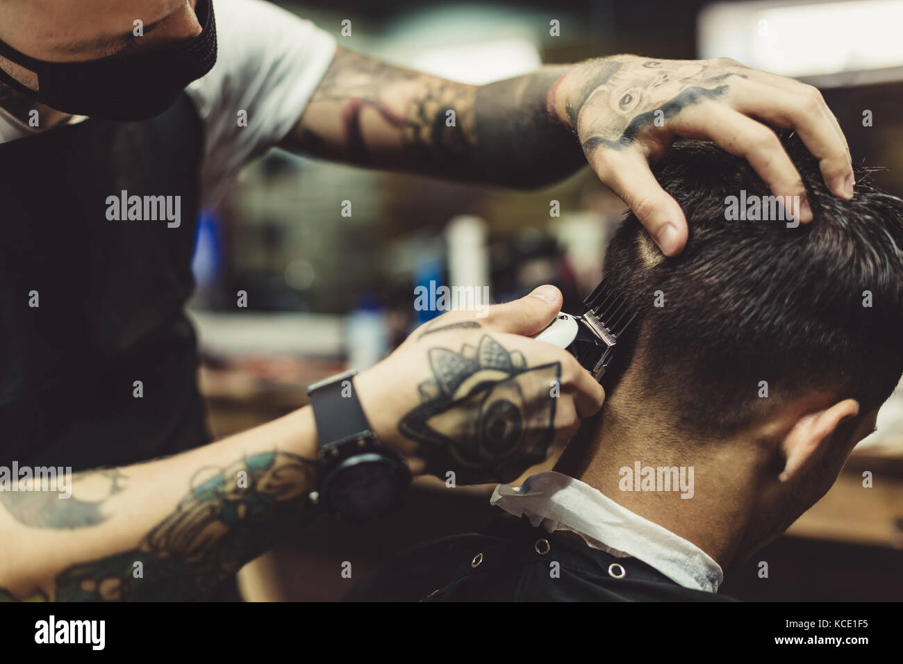 Barber shaving man in chair Stock Photo - Alamy
