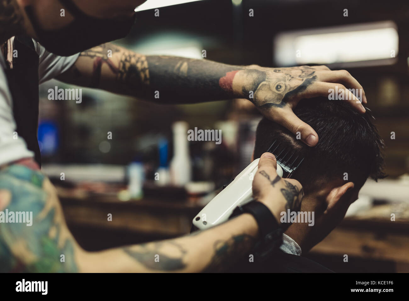 Barber shaving man in chair Stock Photo - Alamy