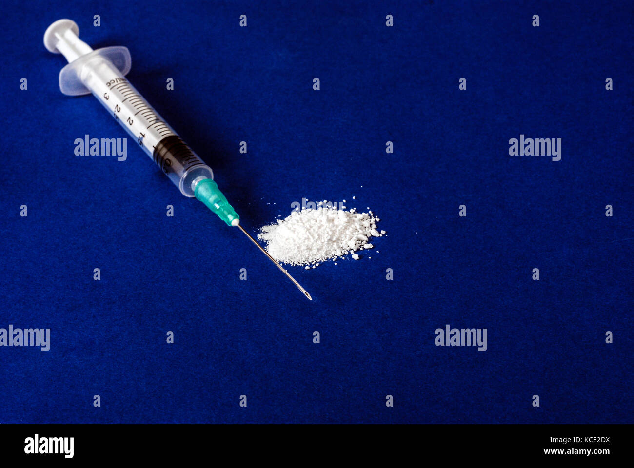 Medical syringe and drug on blu background Stock Photo - Alamy