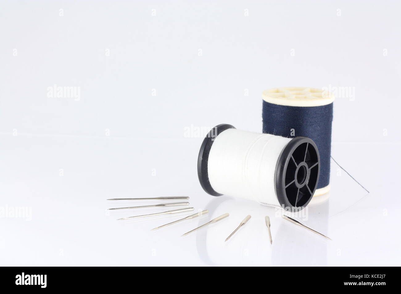 Spool of thread and needle Stock Photo - Alamy
