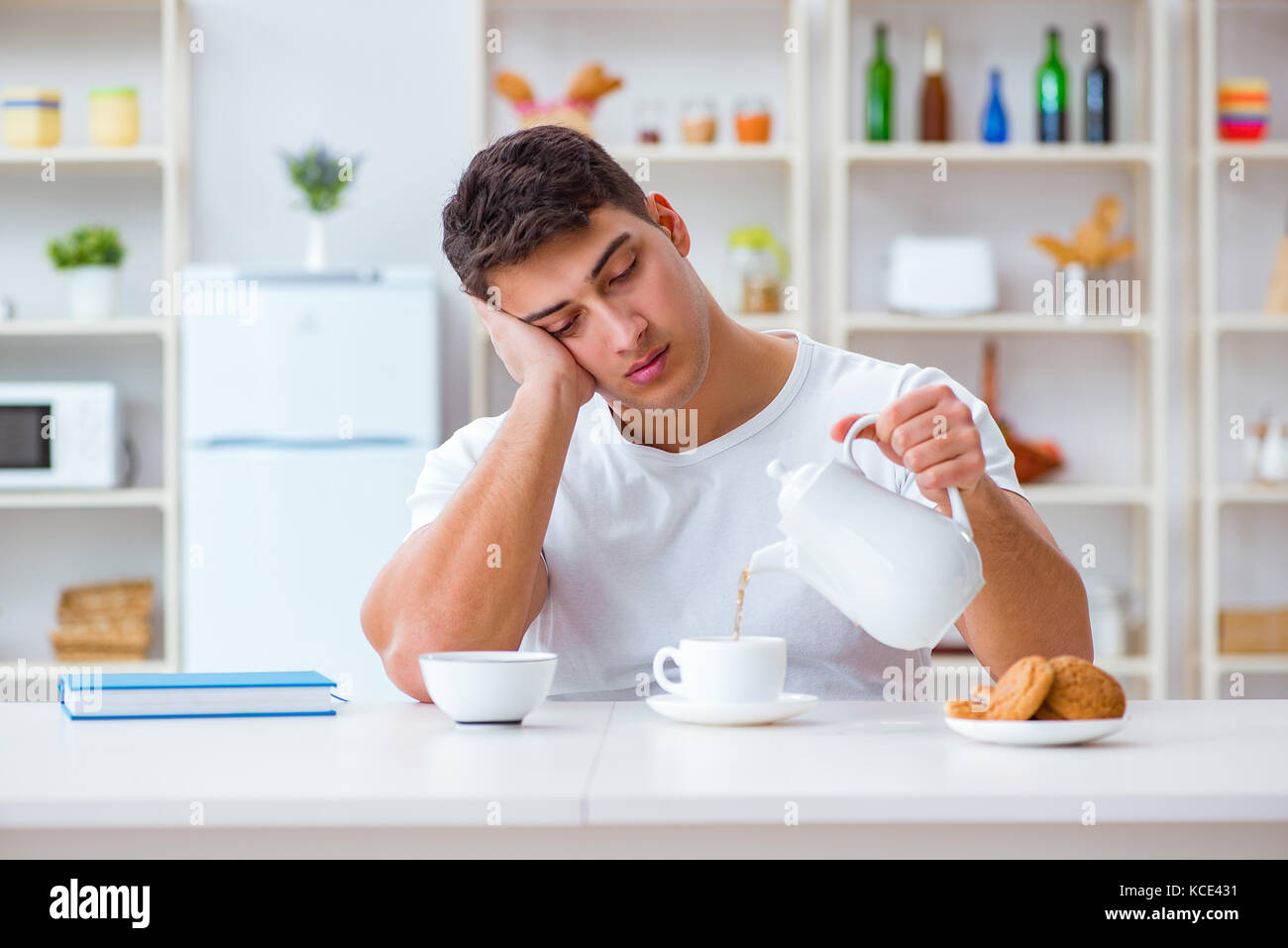 Man falling asleep during his breakfast after overtime work Stock Photo ...