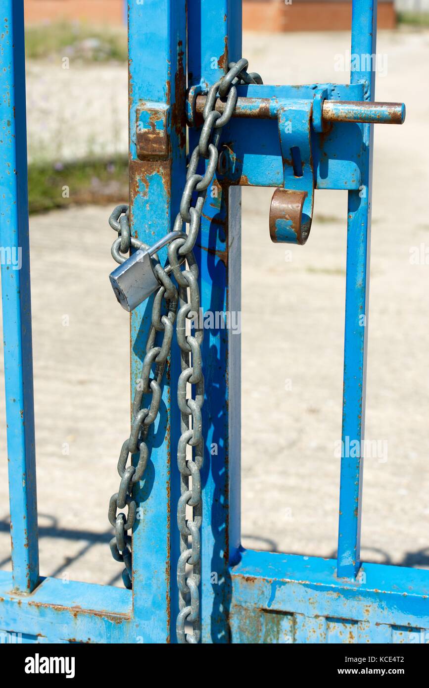 Door closed with a chain and padlock Stock Photo - Alamy