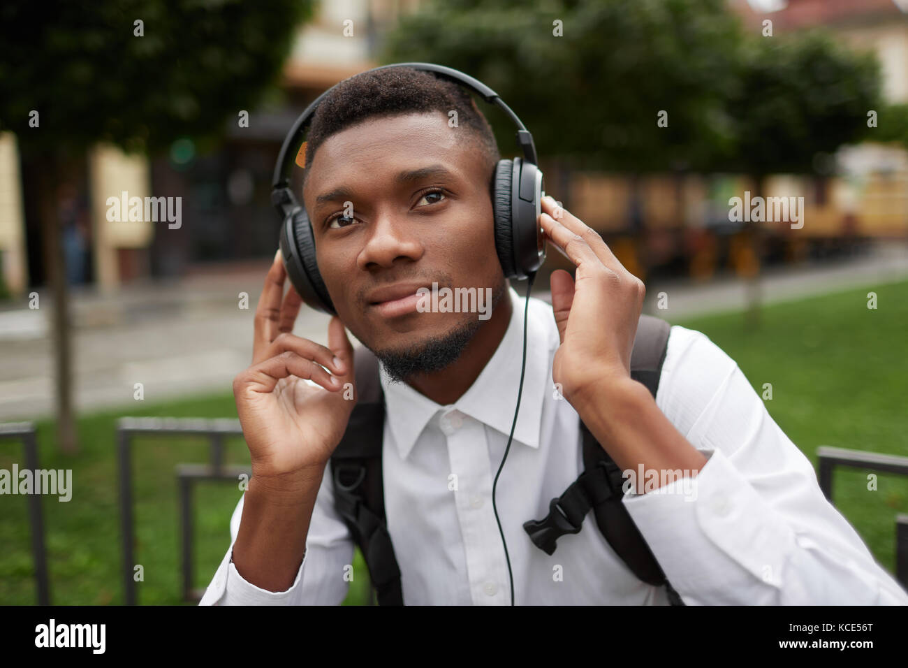 African man resting outdoors and listening music Stock Photo - Alamy