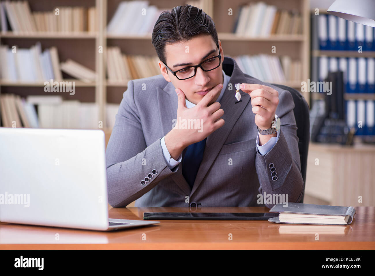 Drug addict businessman in the office Stock Photo - Alamy