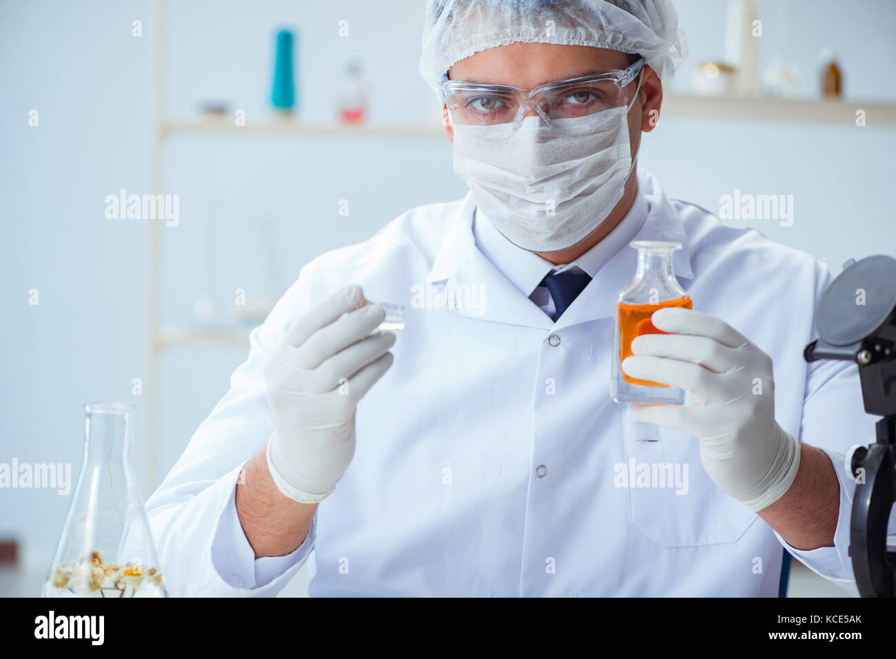 Chemist mixing perfumes in the lab Stock Photo - Alamy