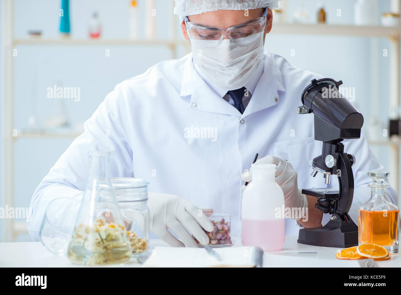 Chemist mixing perfumes in the lab Stock Photo - Alamy