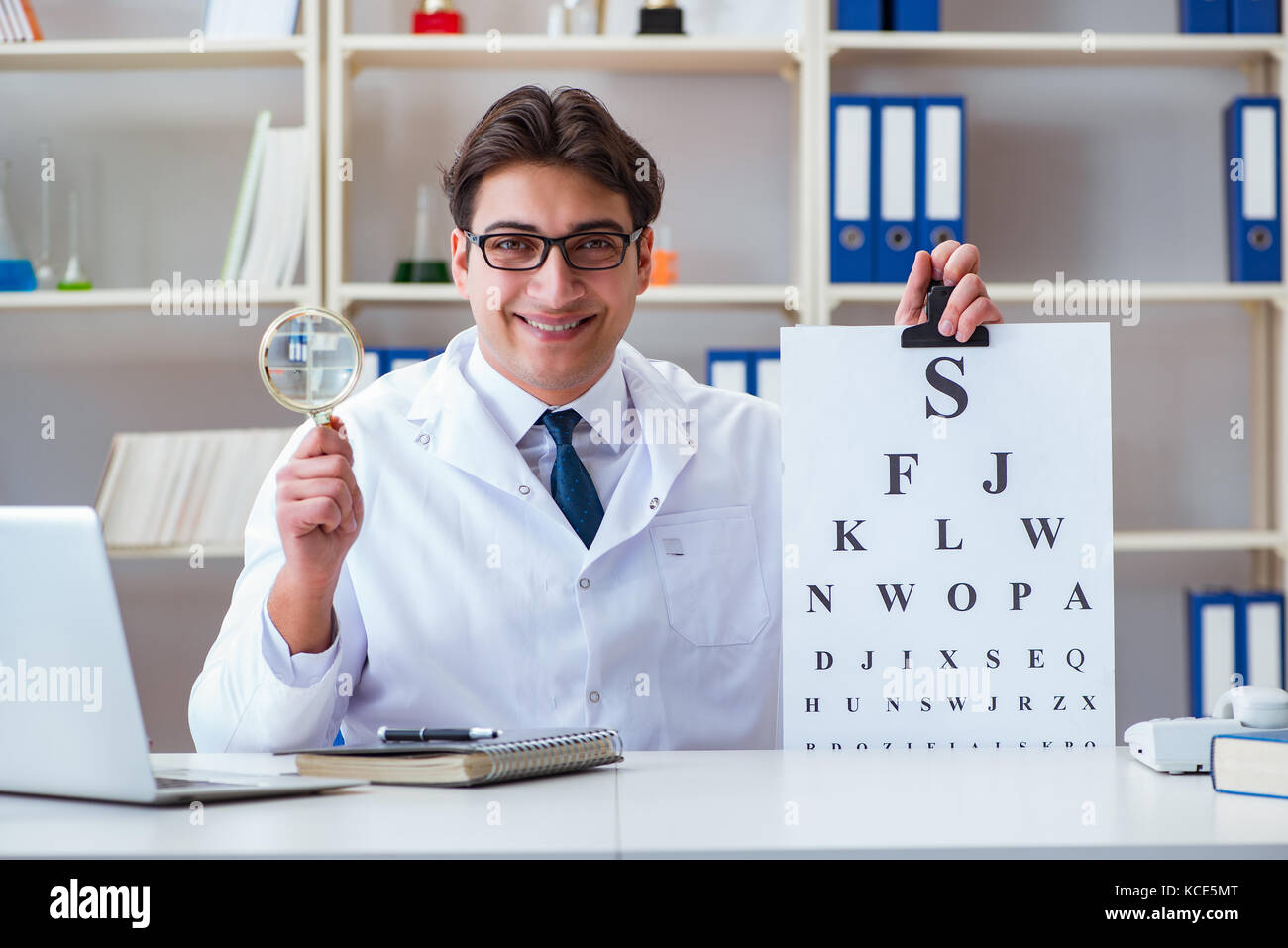 Doctor optician with letter chart conducting an eye test check Stock ...