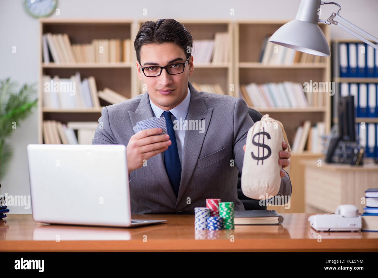 Businessman gambling playing cards at work Stock Photo - Alamy