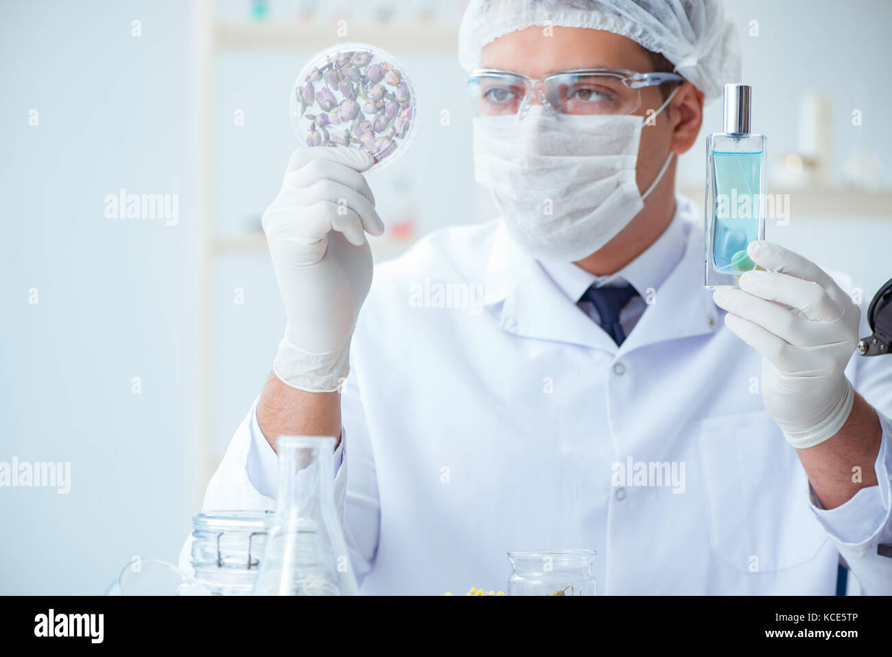 Chemist mixing perfumes in the lab Stock Photo - Alamy