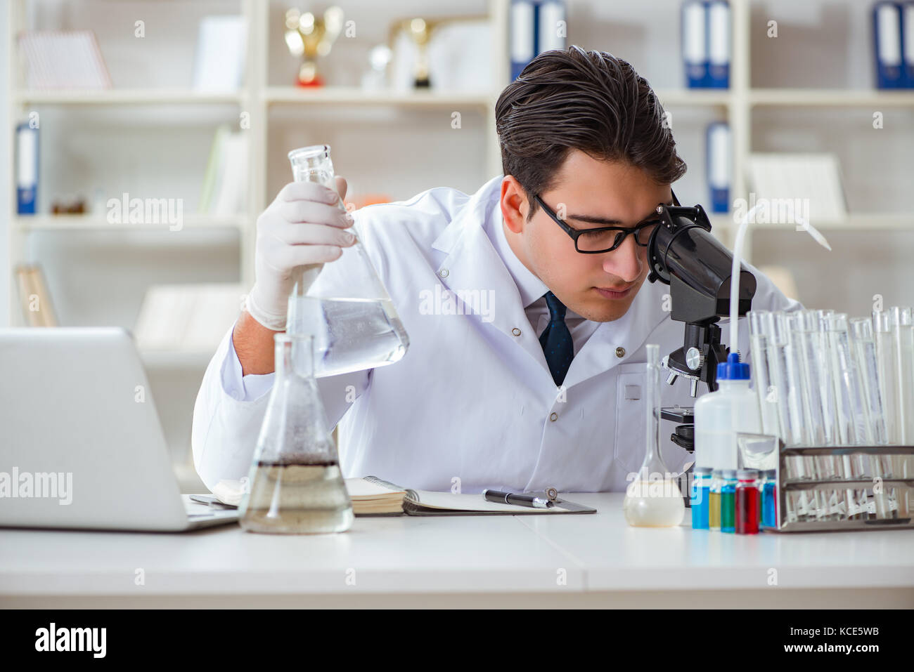 Young researcher scientist doing a water test contamination experiment ...