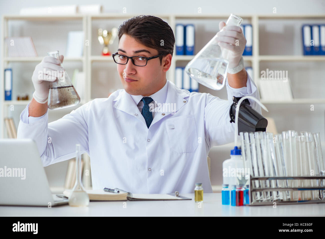 Young researcher scientist doing a water test contamination experiment ...