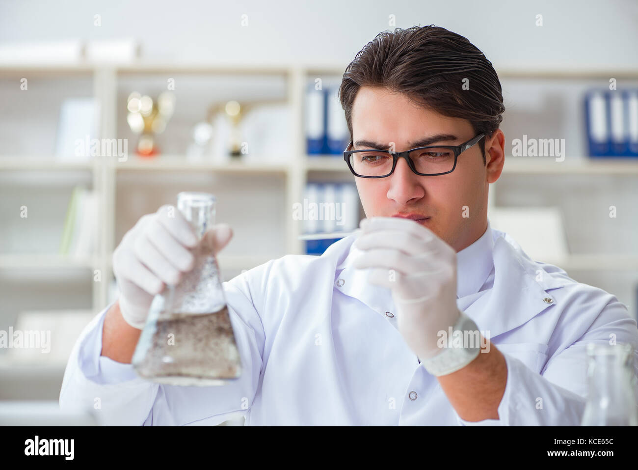Young researcher scientist doing a water test contamination experiment ...