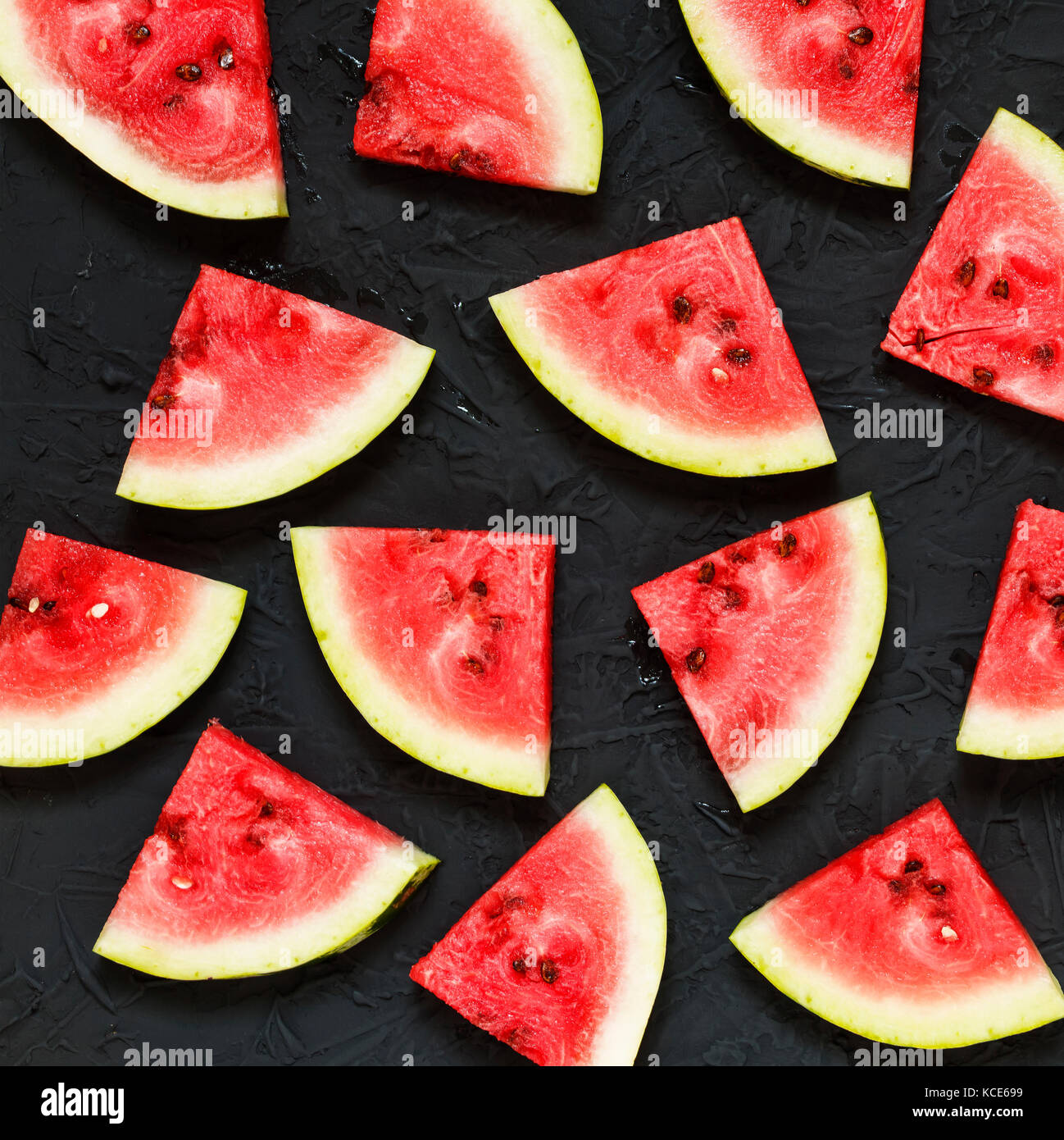 Slices of ripe watermelon on a black stone background Stock Photo - Alamy