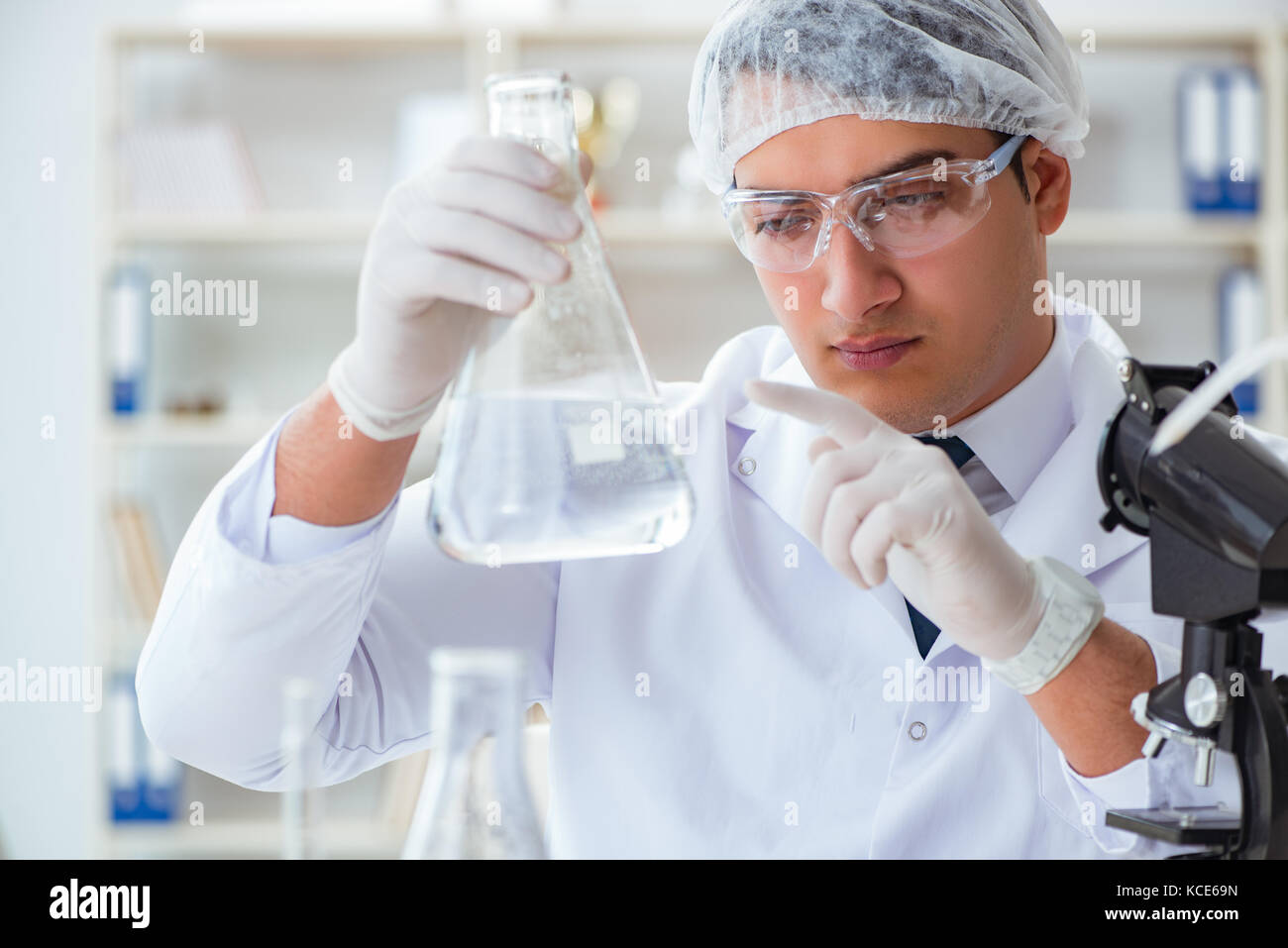 Young researcher scientist doing a water test contamination experiment ...
