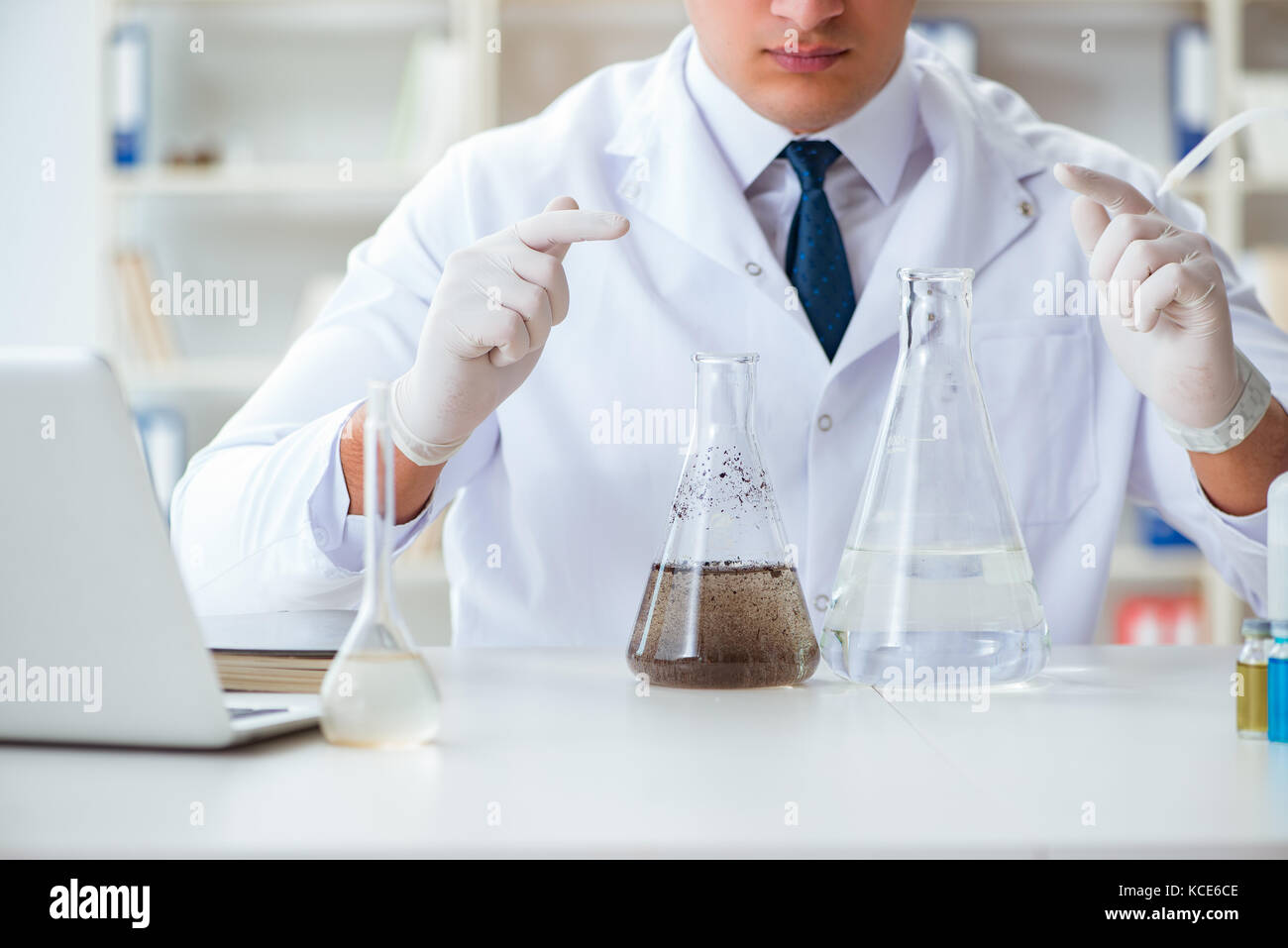 Young researcher scientist doing a water test contamination experiment ...