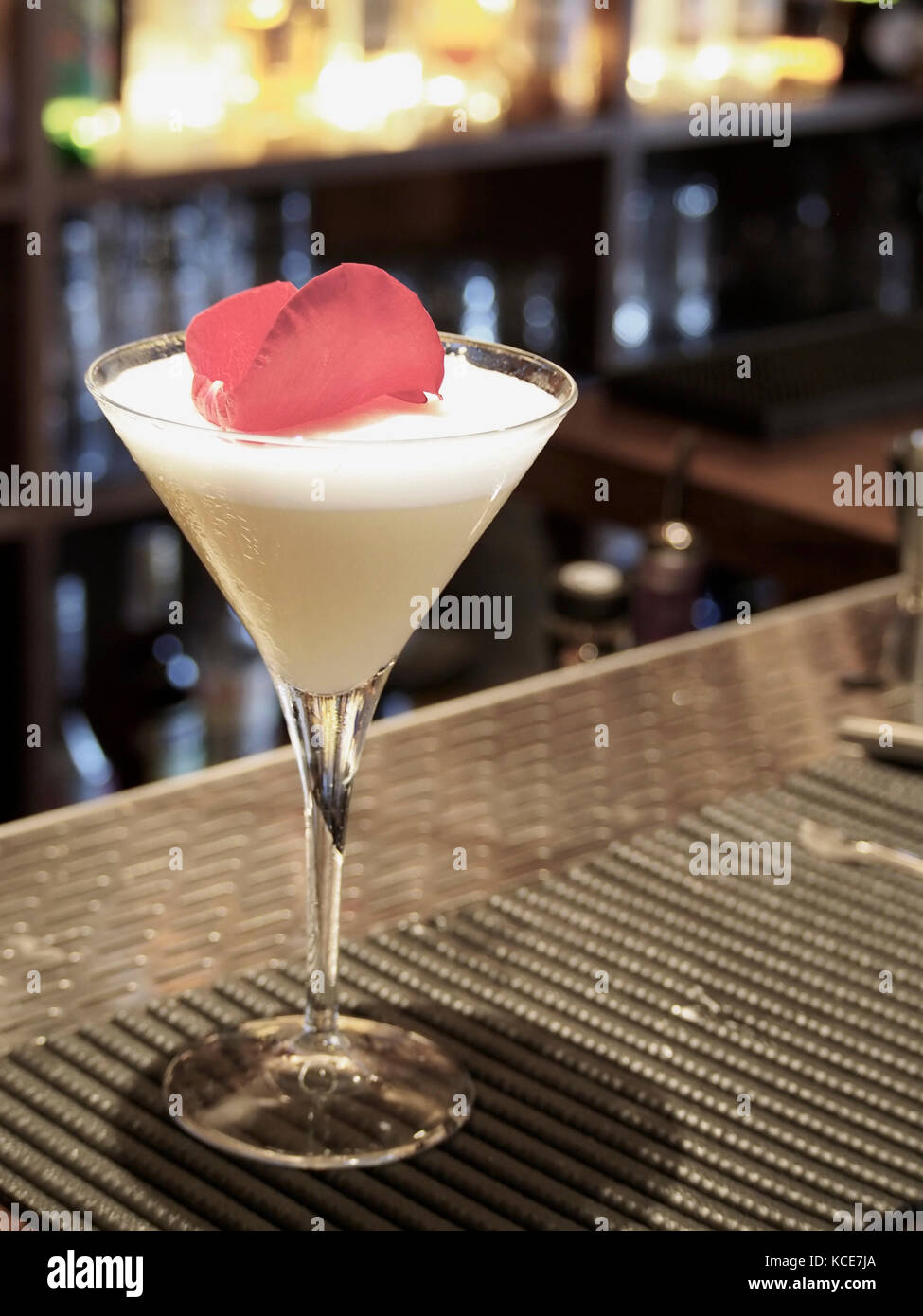 Cocktail with red rose leaf Stock Photo - Alamy