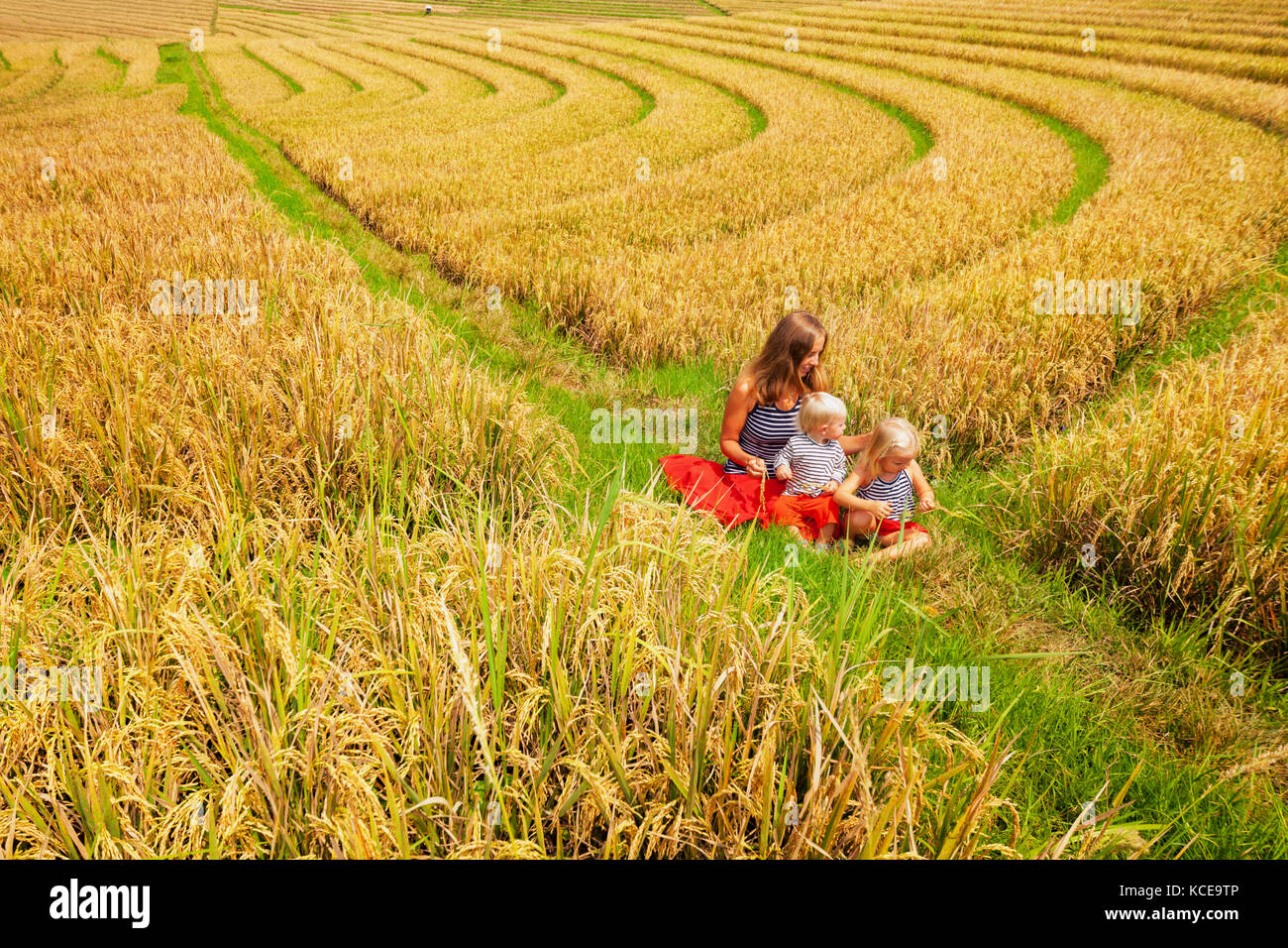 Happy mother, daughter, baby son walk with fun in terrace plantation ...