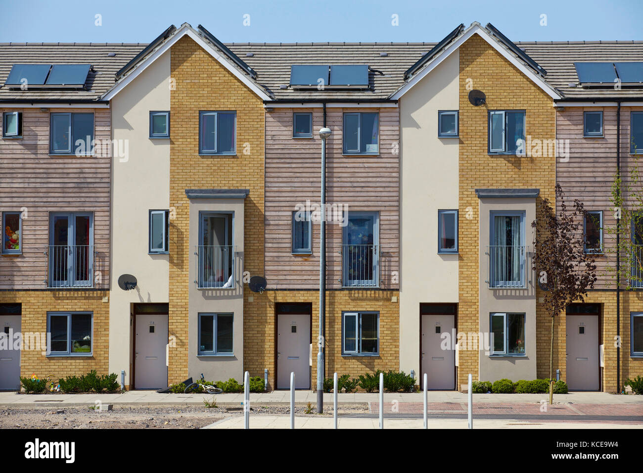 New village, 2013, terrace with solar panels, Juliet balconies and ...
