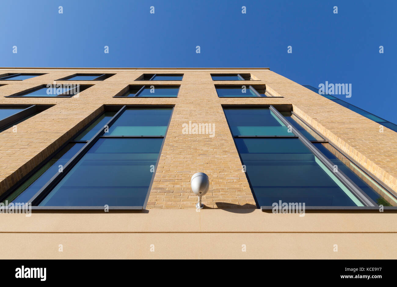 Looking up windows and facade of a commercial building with light ...