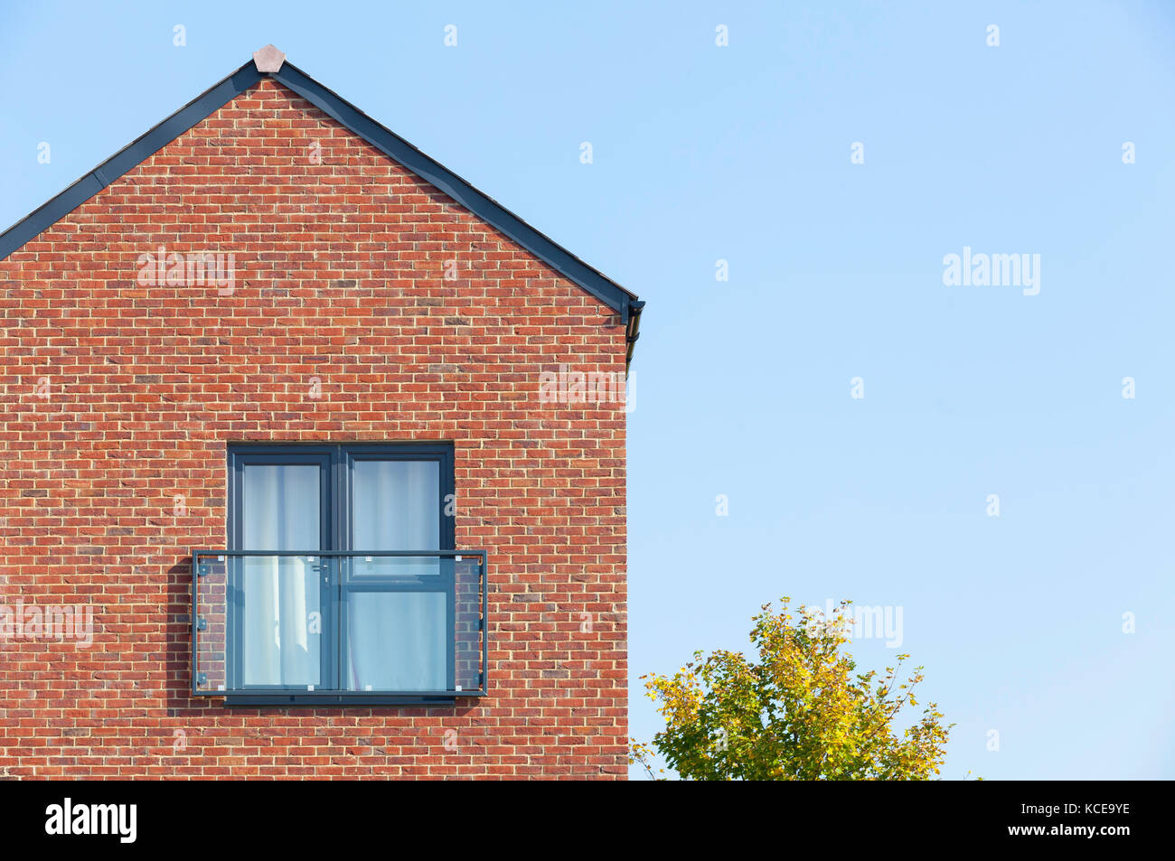End elevation of new build brick home with window and Juliet balcony ...
