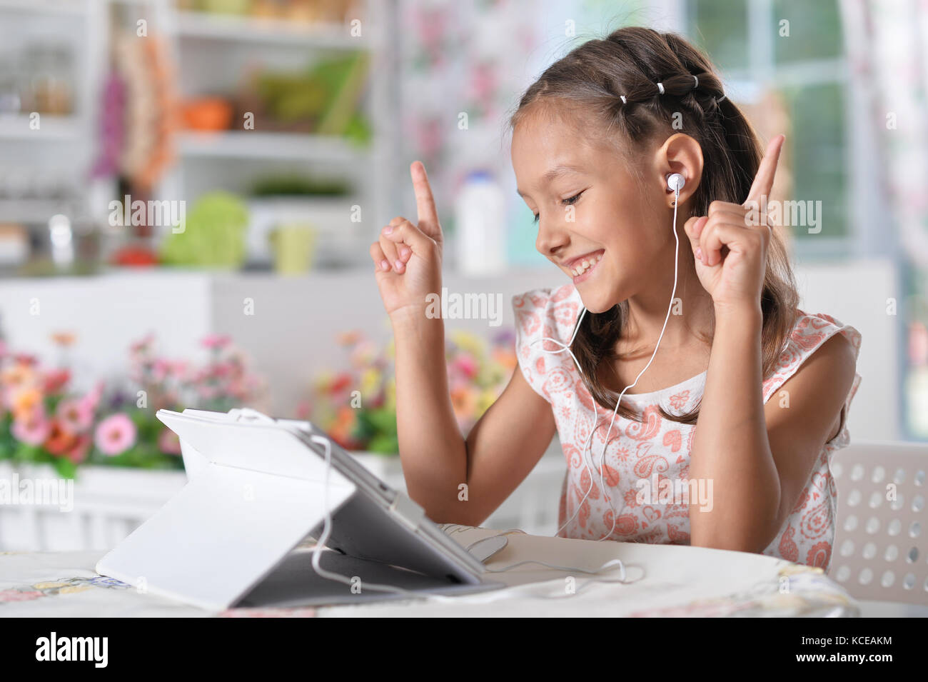 Cute girl with digital tablet Stock Photo - Alamy