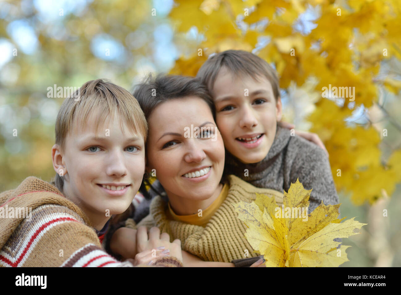 Happy family in autumn forest Stock Photo - Alamy