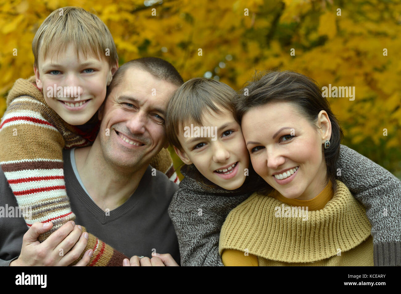 smiling family in autumn forest Stock Photo - Alamy