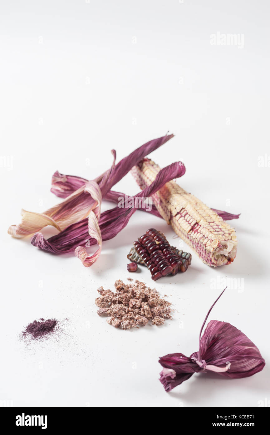 Black glutinous corn components on white table including kernels, dried ...