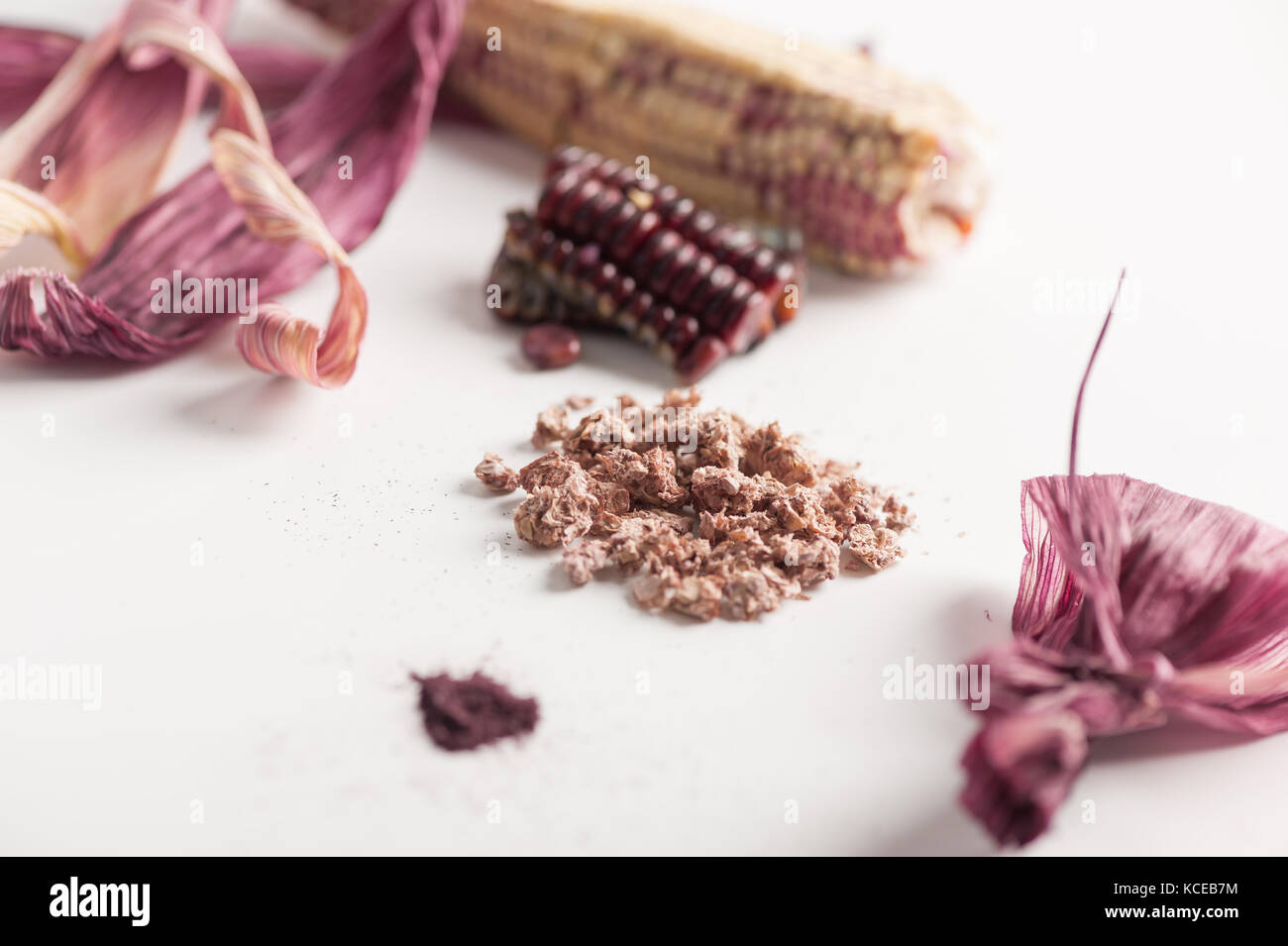 Black glutinous corn components on white table including kernels, dried ...
