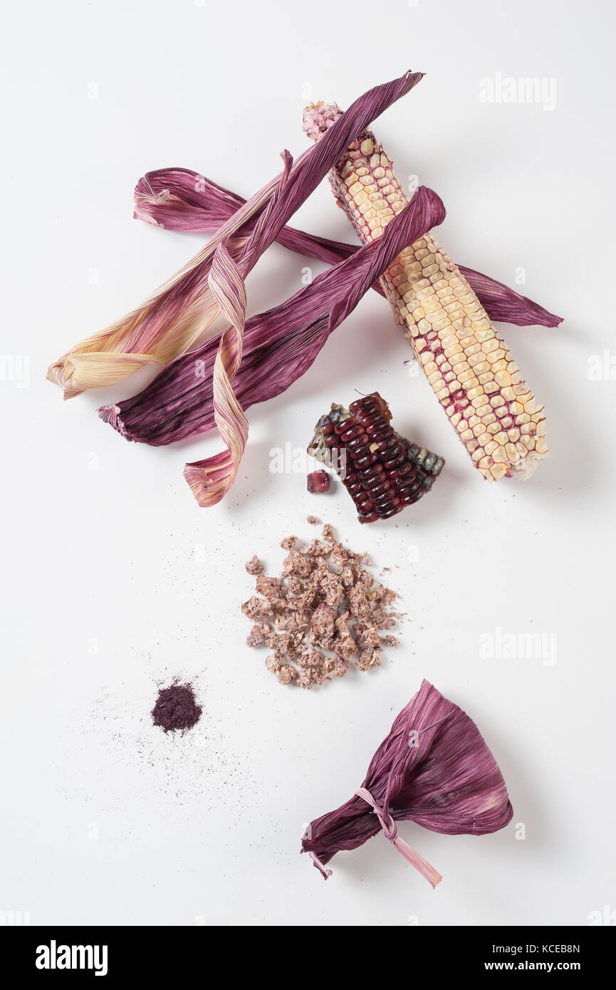 Black glutinous corn components on white table including kernels, dried ...