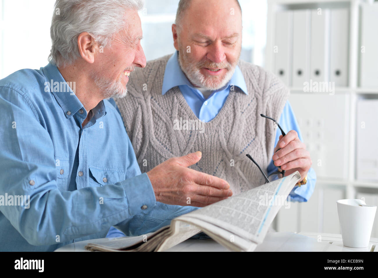 senior men reading newspaper Stock Photo - Alamy