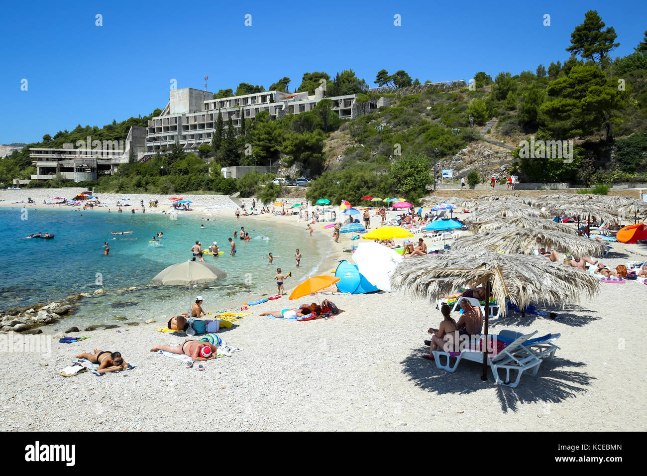 KUPARI, CROATIA - JULY 18, 2017 : People swimming and sunbathing on a ...