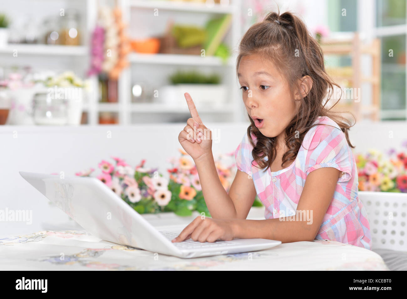 Little girl using laptop Stock Photo - Alamy