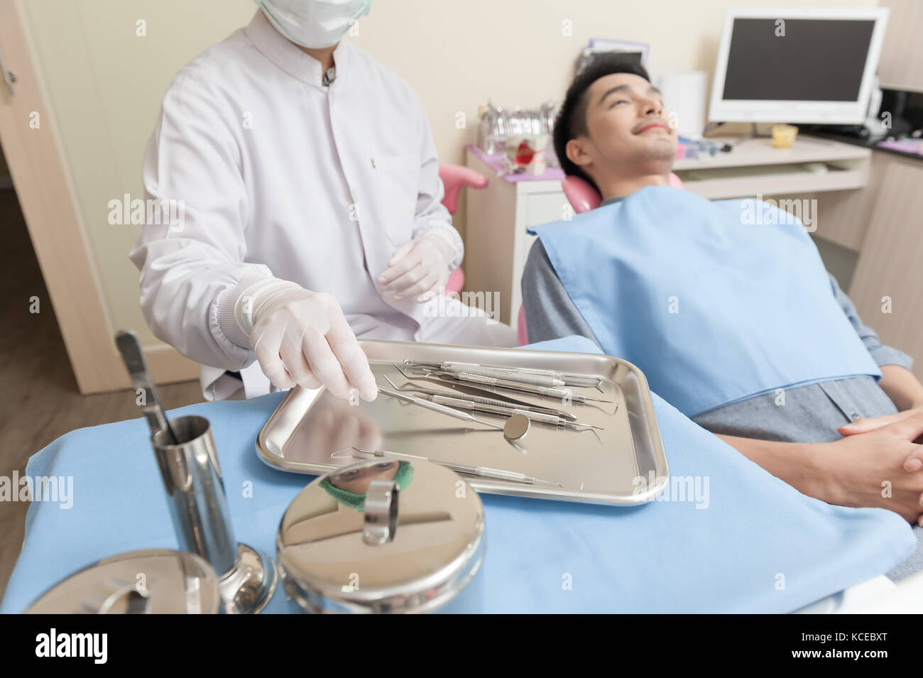 Dentist hand pick some instruments from metal tray in clinic. Dental ...