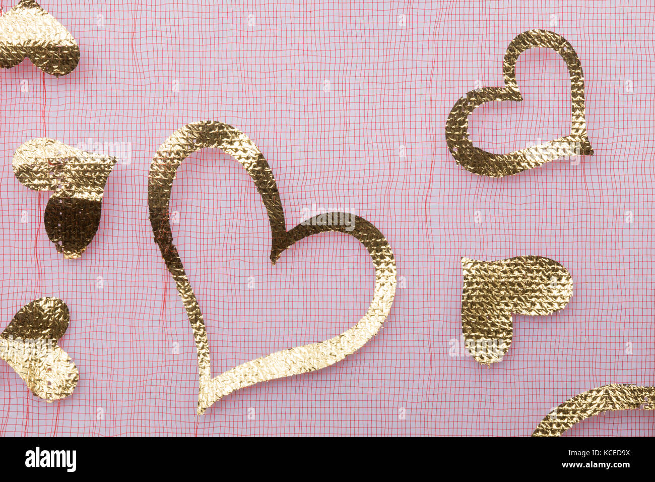 Gold color heart shaped on fabric net background Stock Photo - Alamy