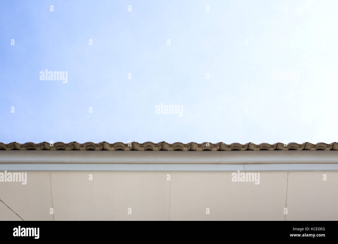 Bottom view of tile roof against blue sky Stock Photo - Alamy