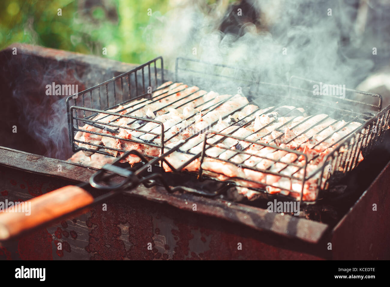 skewers on grilling mesh and grill and smoke Stock Photo - Alamy