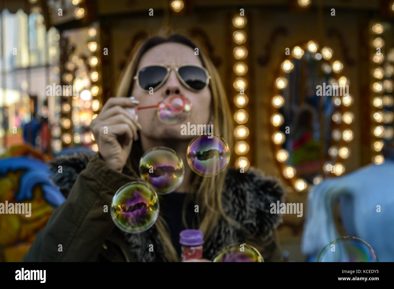 A young female model blowing bubbles Stock Photo - Alamy