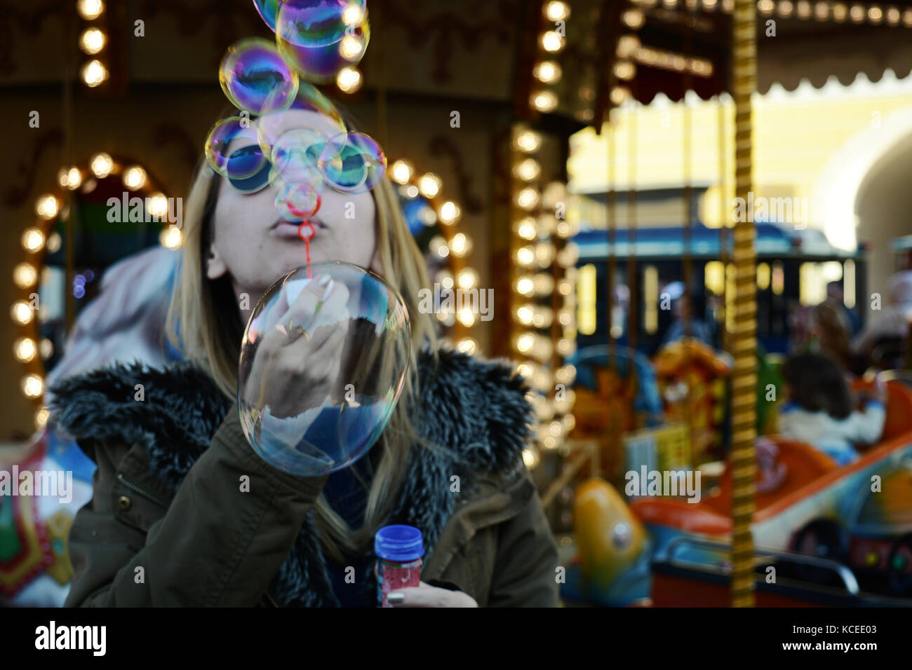 A young female model blowing bubbles Stock Photo - Alamy