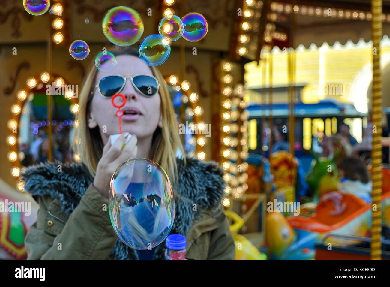 A young female model blowing bubbles Stock Photo - Alamy