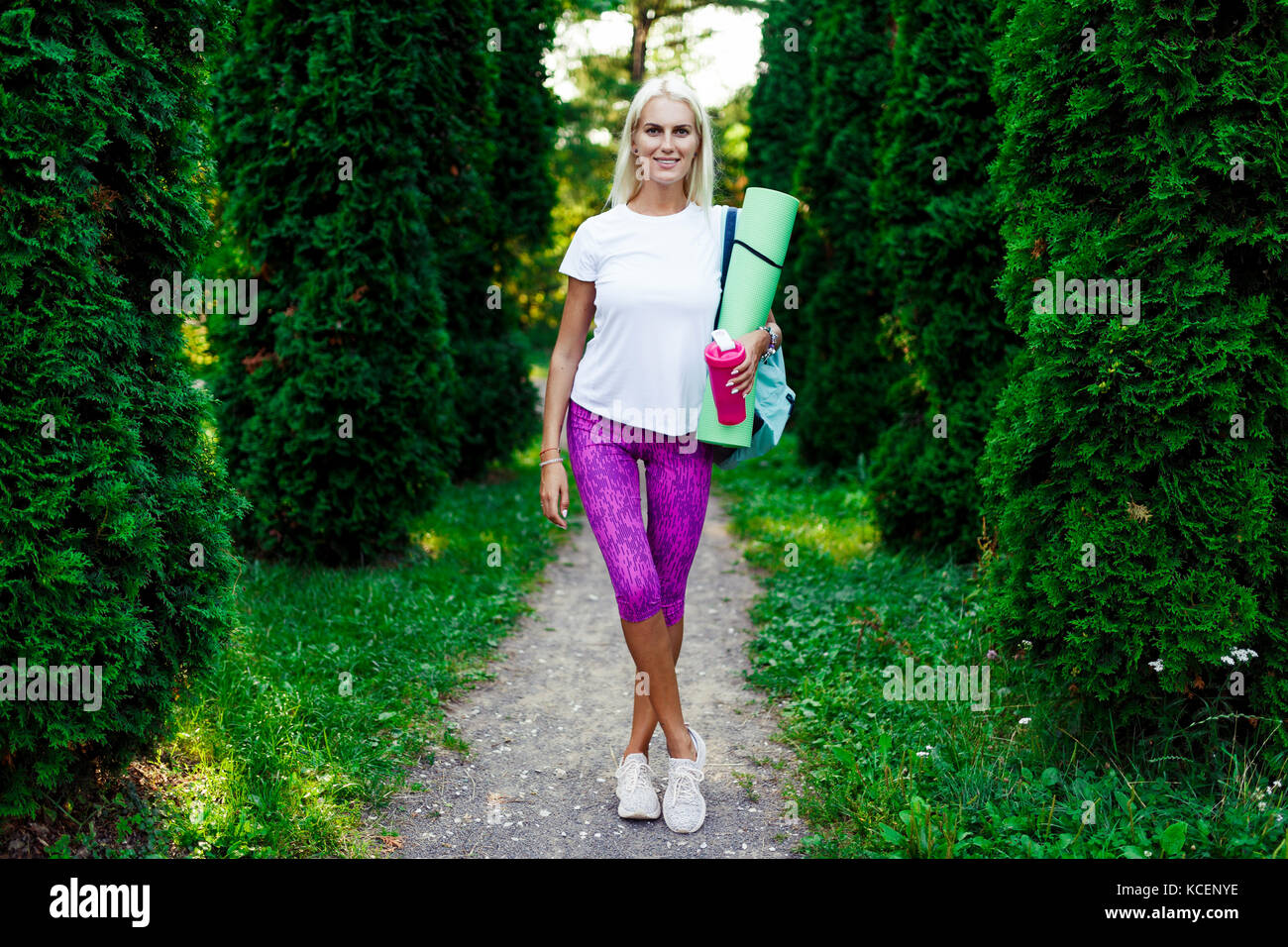 Image of sporty woman with rug in hands Stock Photo - Alamy