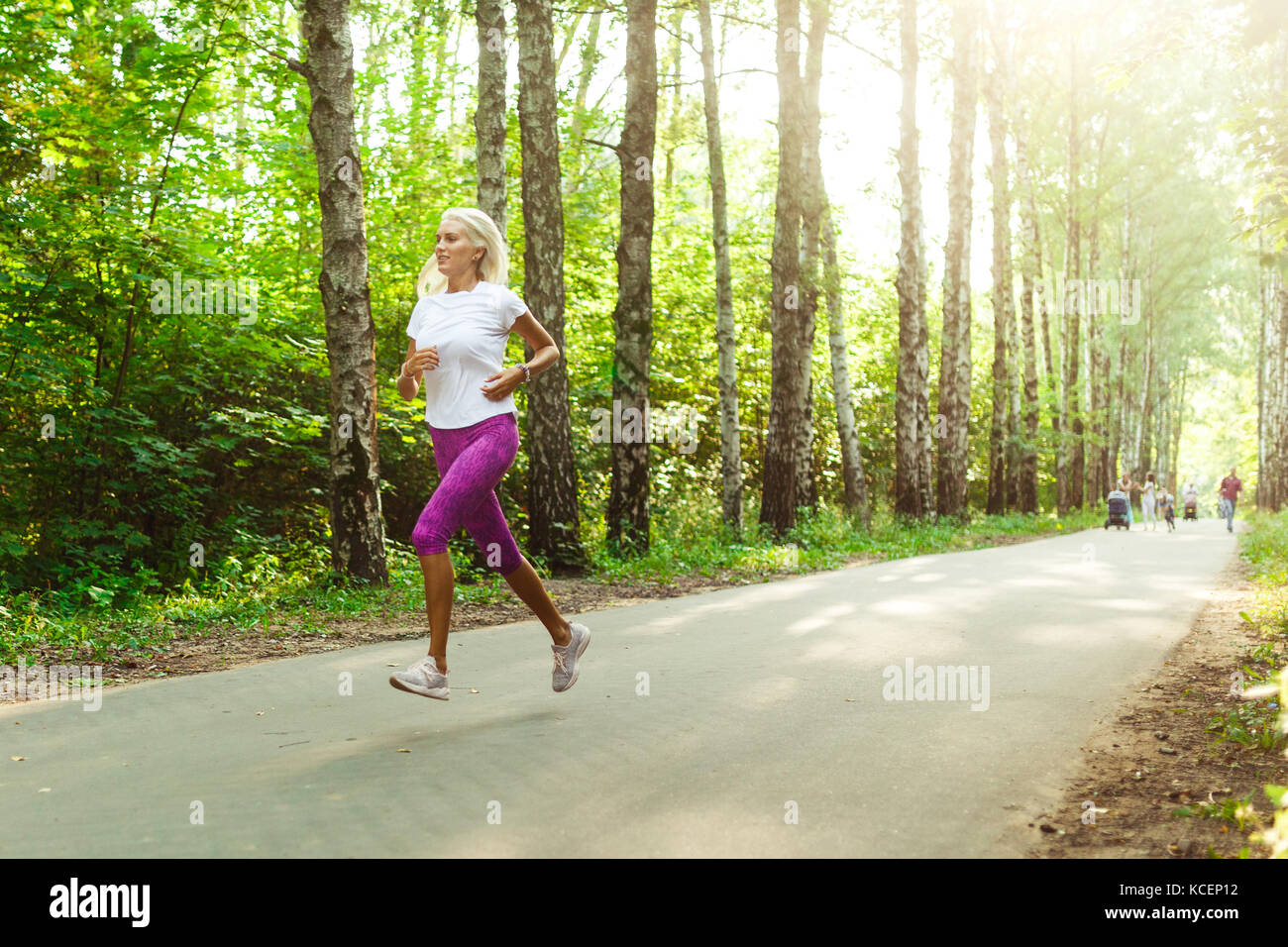 Picture of sports girl jogging on road Stock Photo - Alamy