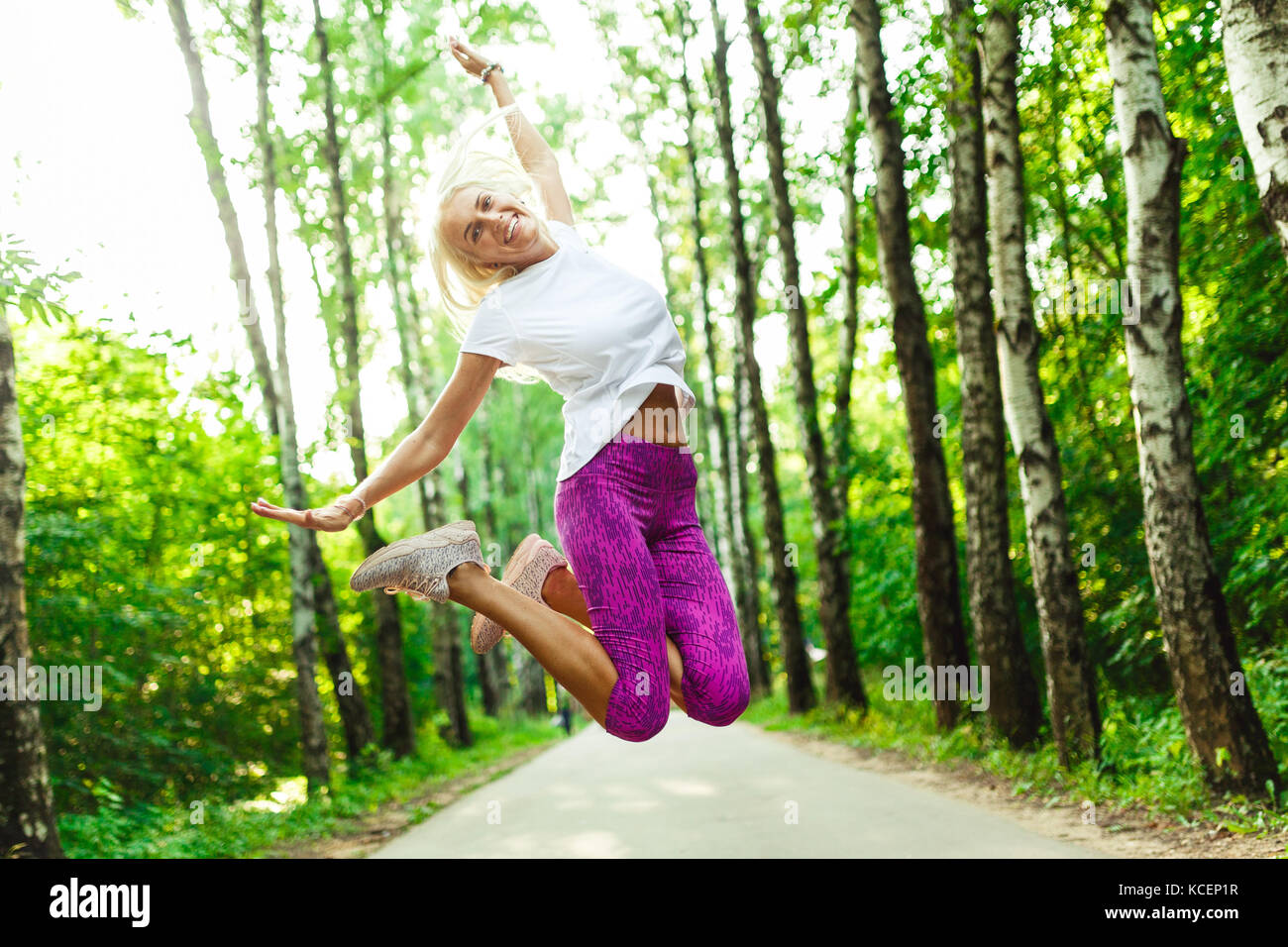 Girl jumping in forest hi-res stock photography and images - Alamy