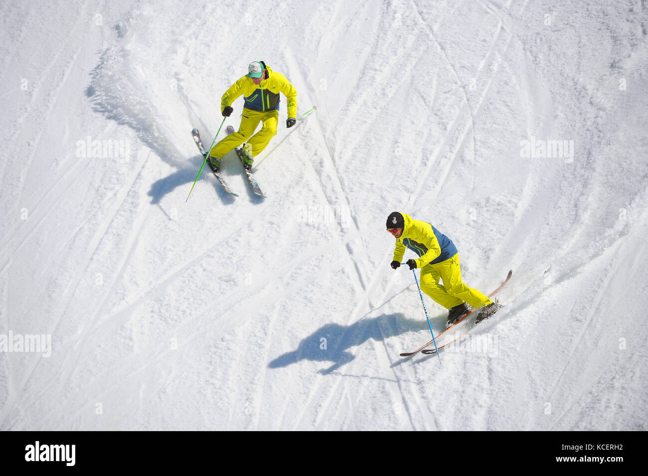 Two skiers carve turns photographed from above Stock Photo - Alamy