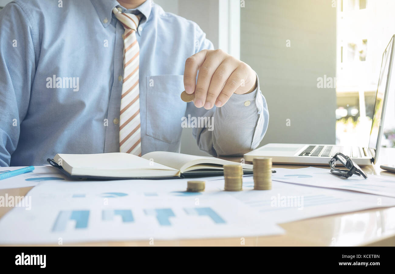 Close-up of Businessman putting coin to rising stack of coins Stock ...