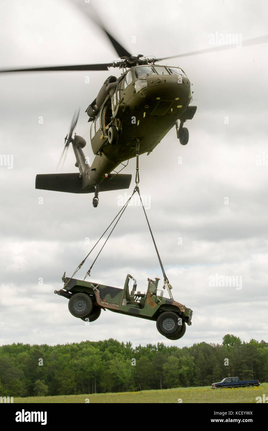 A U.S. Army UH-60 Black Hawk departs carrying a Humvee during the sling ...