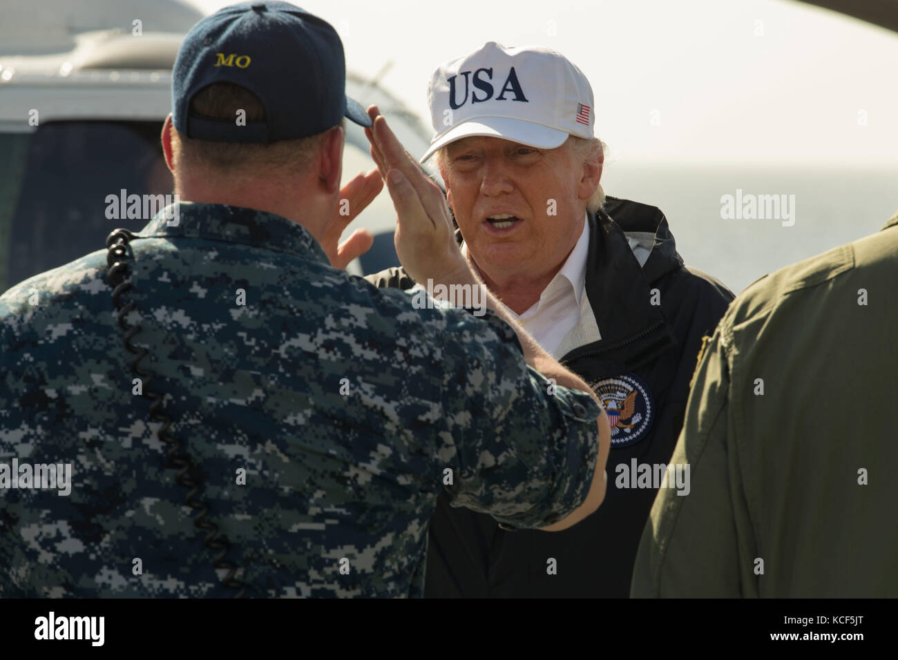 U.S President Donald Trump returns a salute to Lt. Cmdr. Todd Dupree ...