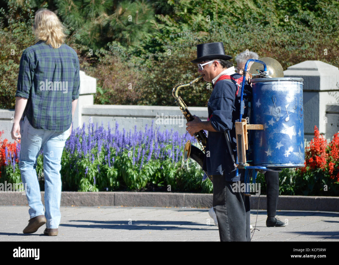 A street musician plays on a one-man band during Canada 150 ...