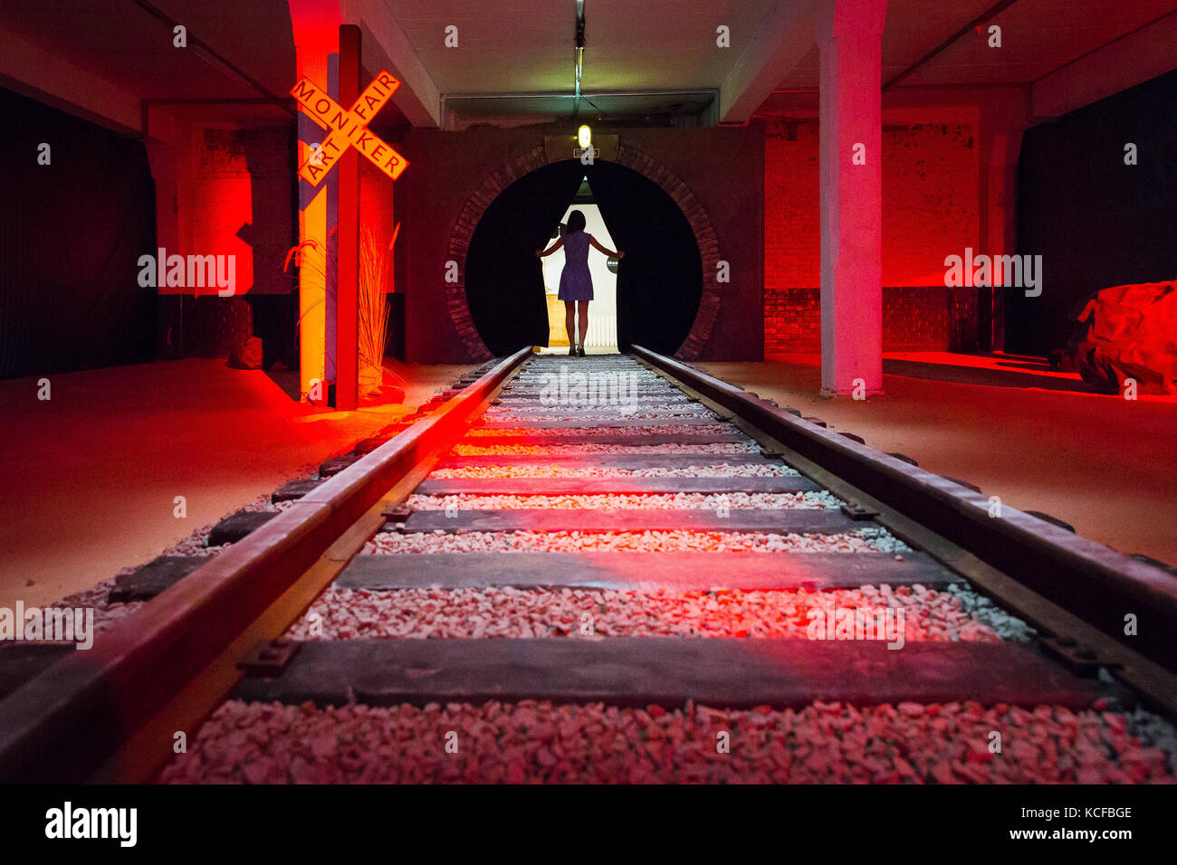 London, UK. 5th Oct, 2017. A woman stands on the train tracks ...