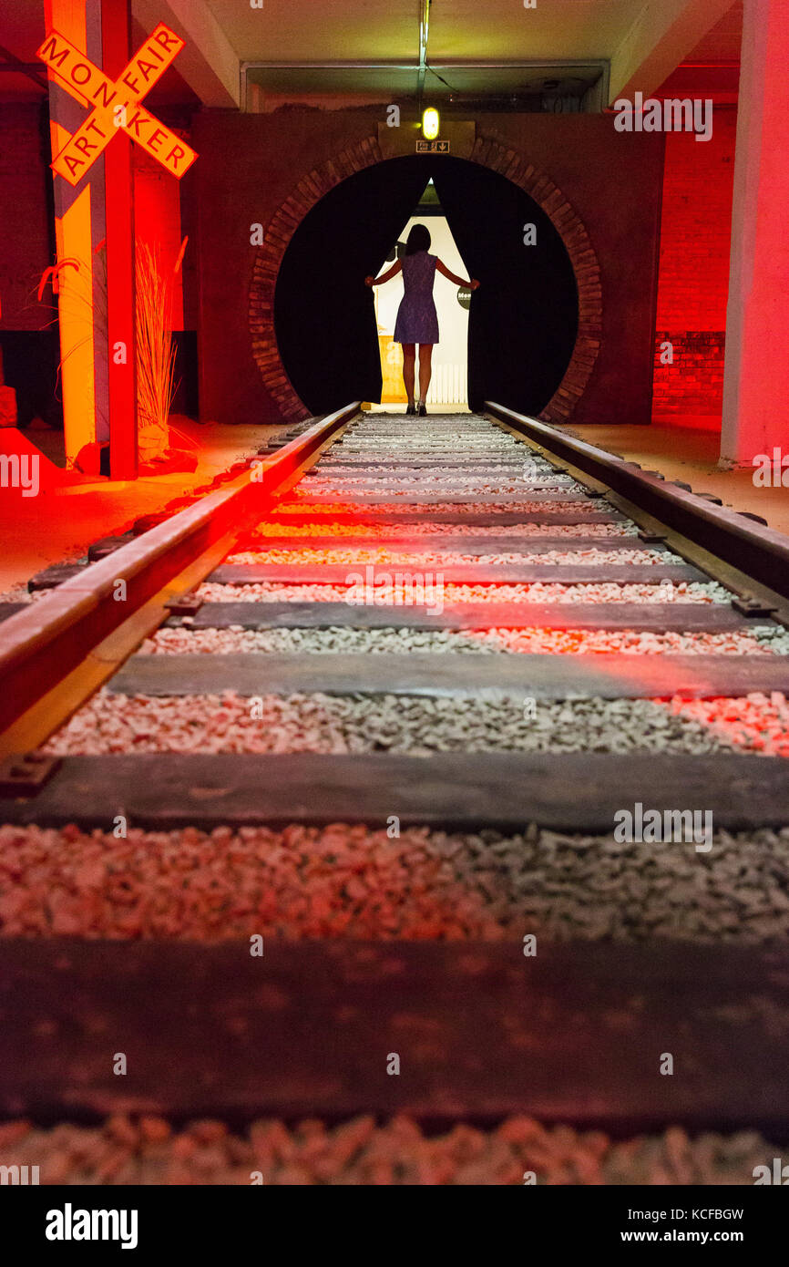 London, UK. 5th Oct, 2017. A woman stands on the train tracks ...